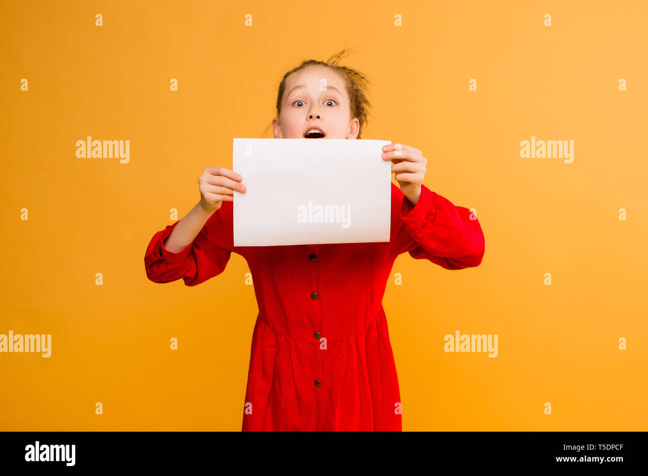 girl holding white sheet.Cute little girl with white sheet of paper ...