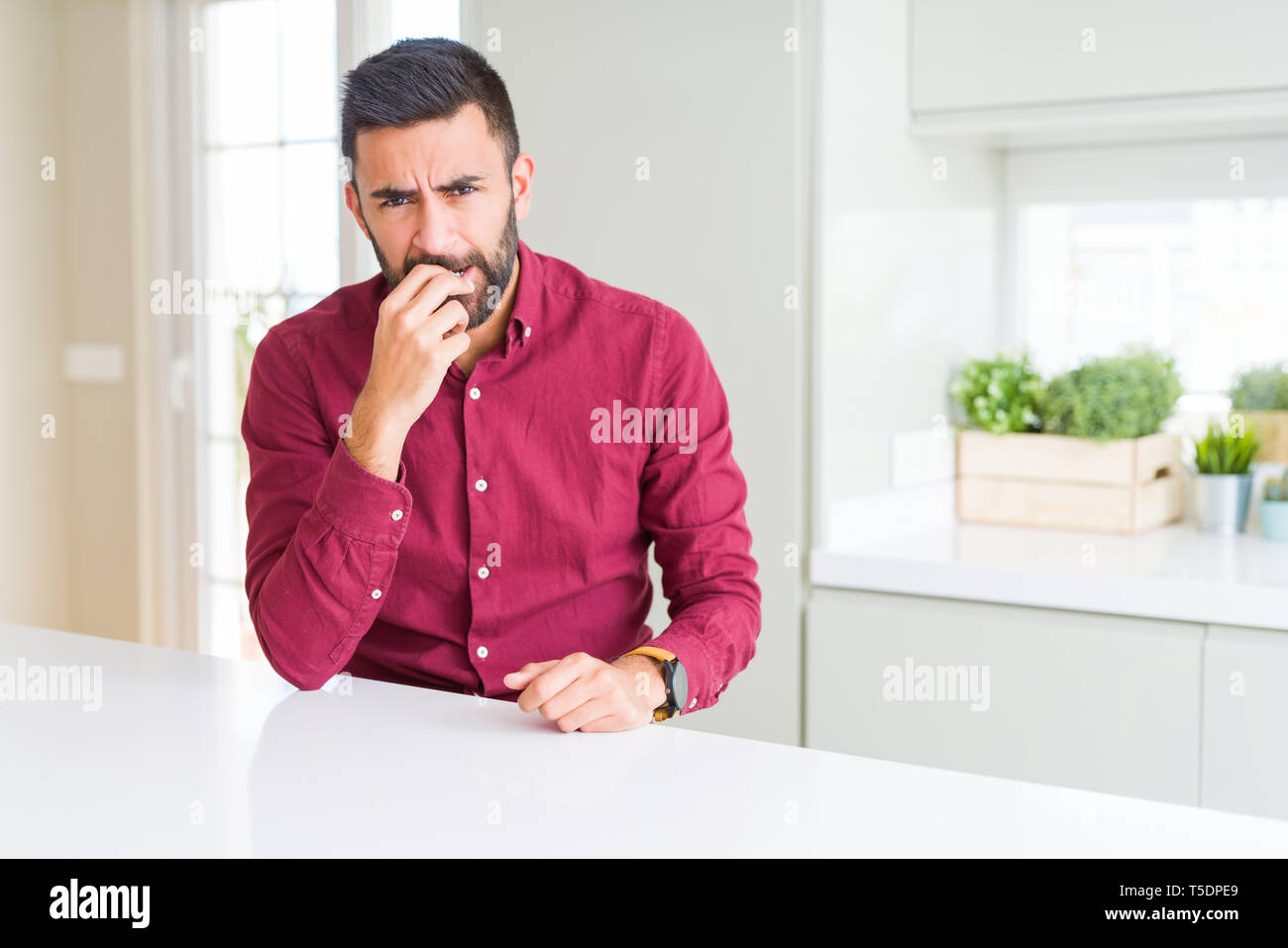 Handsome hispanic business man looking stressed and nervous with hands ...