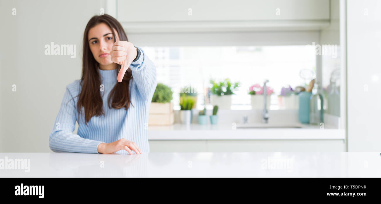 Wide angle picture of beautiful young woman sitting on white table at ...