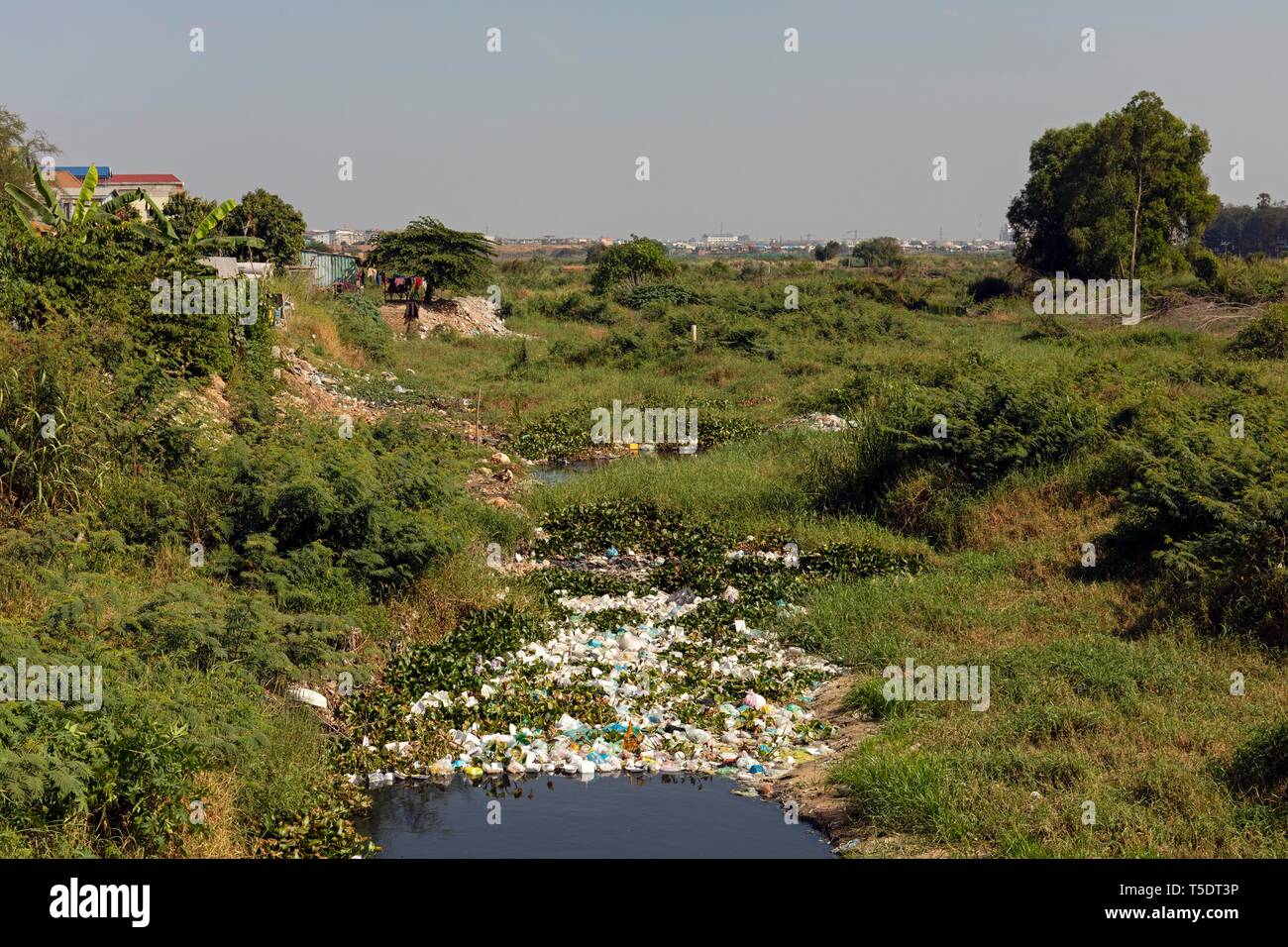 Plastic garbage and plastic bottles washed up in a stream, pollution ...