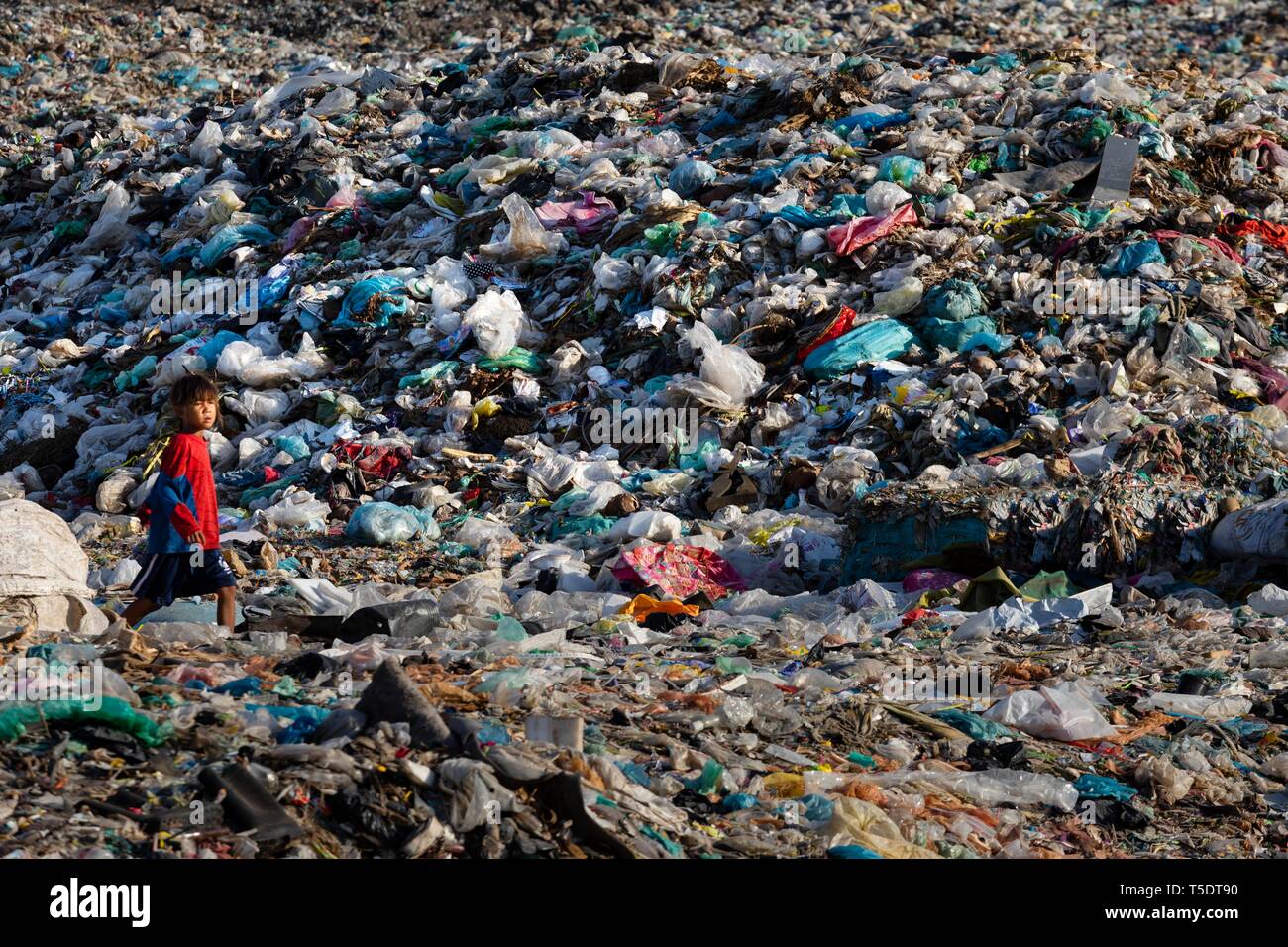 Little girl in garbage dump, garbage collector, garbage dump with ...