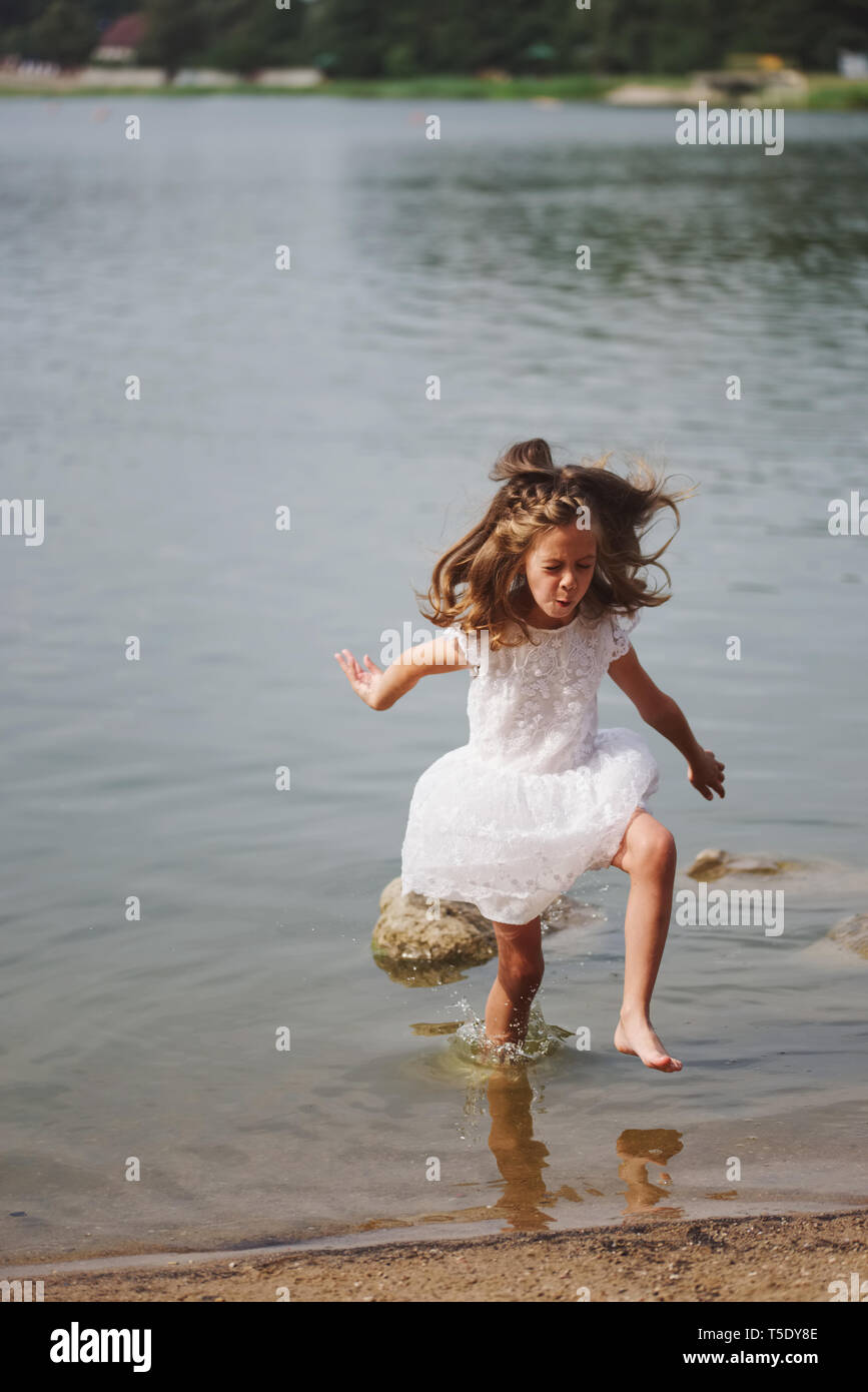 portrait of cute little girls in sumer lake Stock Photo - Alamy