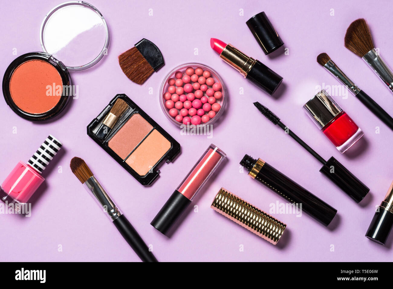 Makeup professional cosmetics on purple background Stock Photo - Alamy