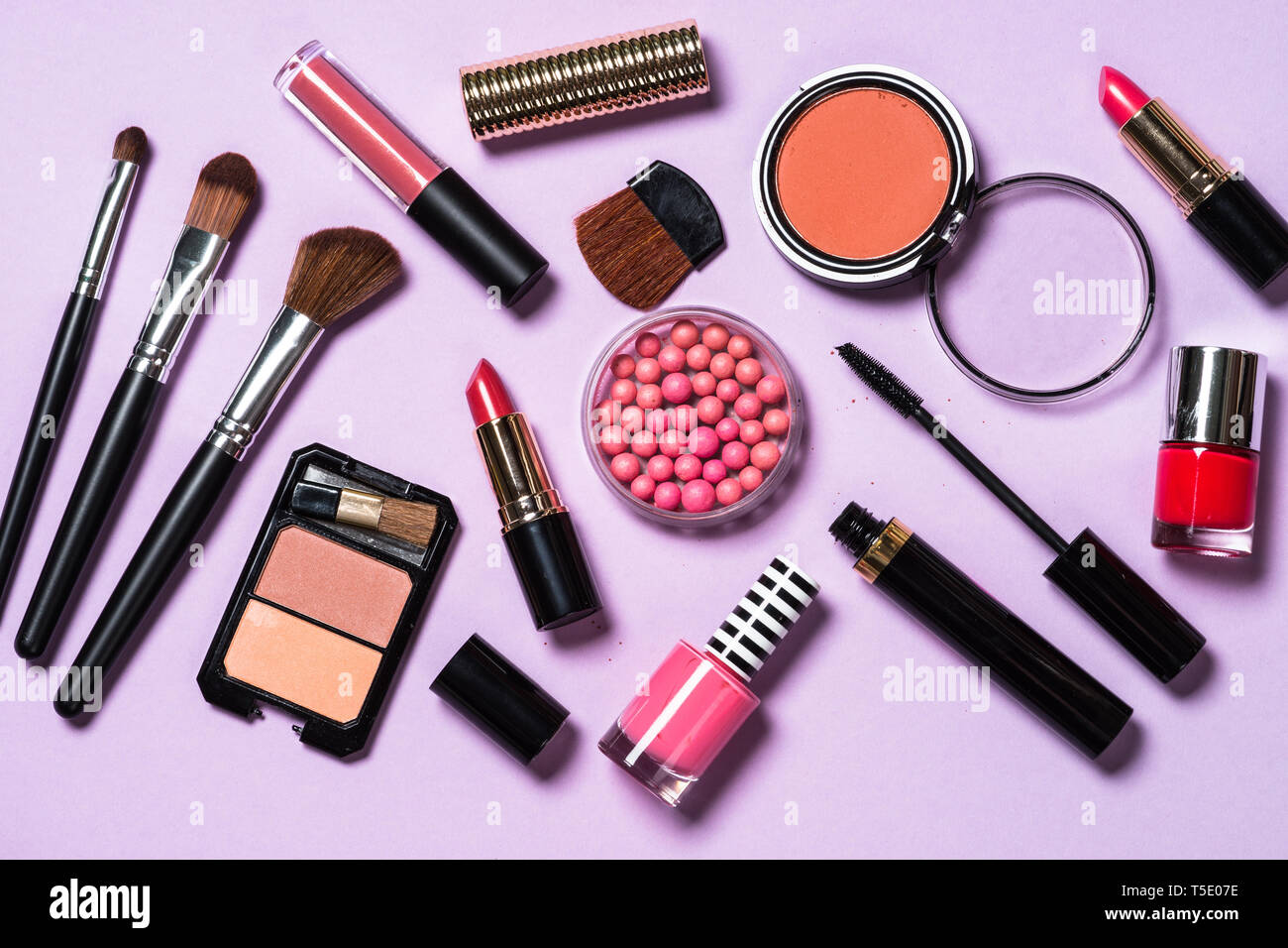 Makeup professional cosmetics on purple background Stock Photo - Alamy