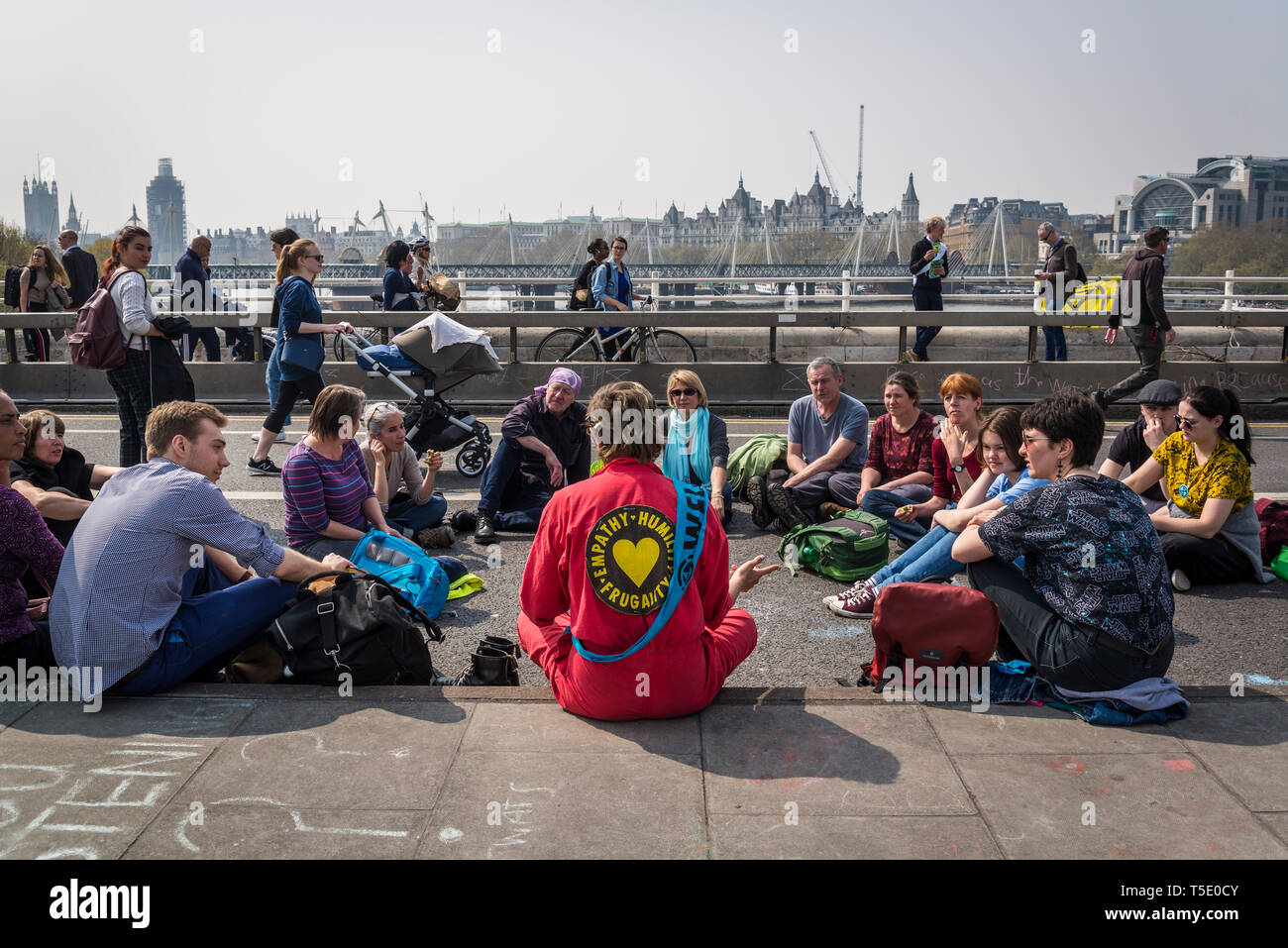 Extinction Rebellion protest on Waterloo Bridge, People sitting in a ...