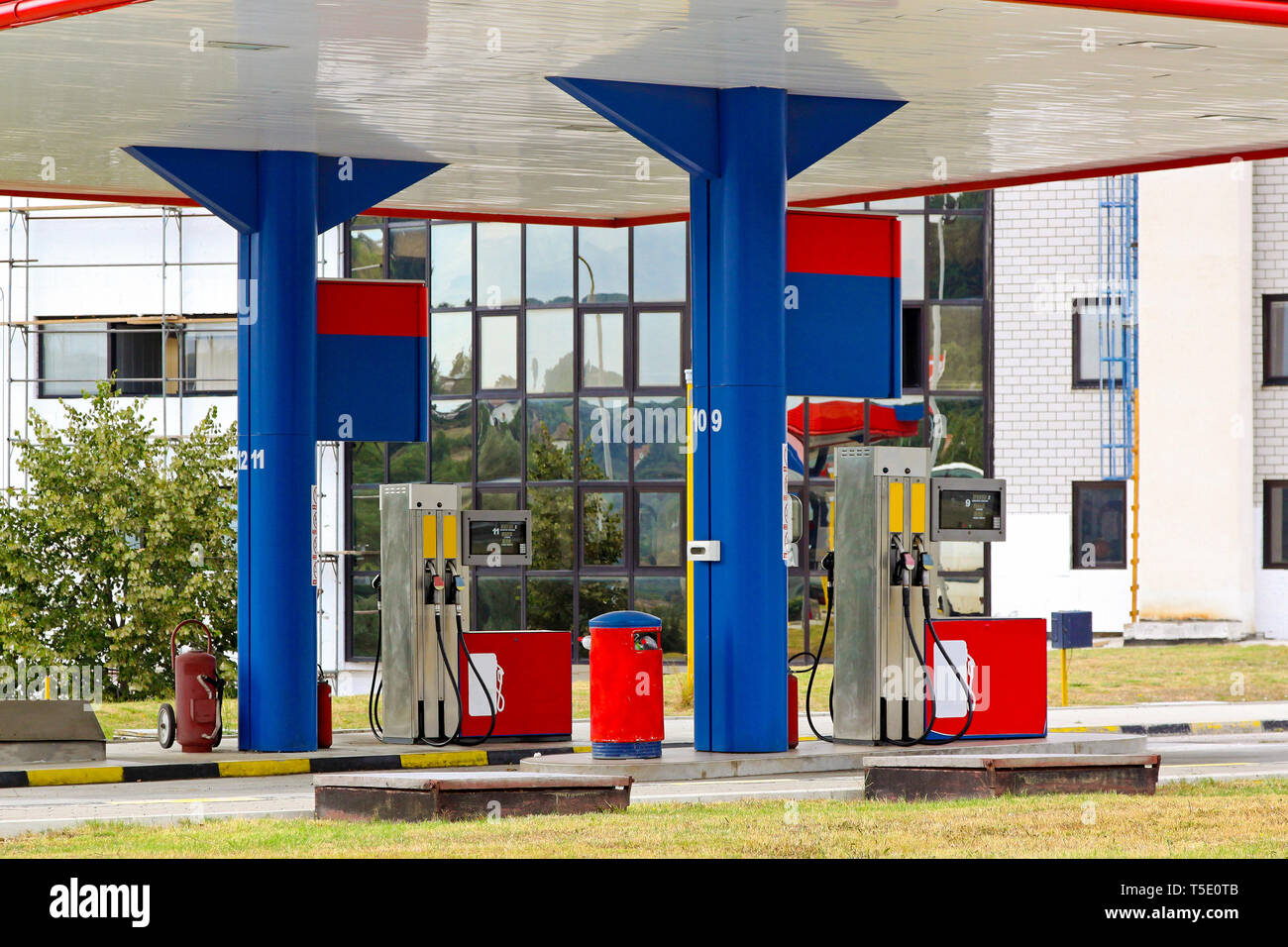 Gas station with glass building in the back Stock Photo - Alamy