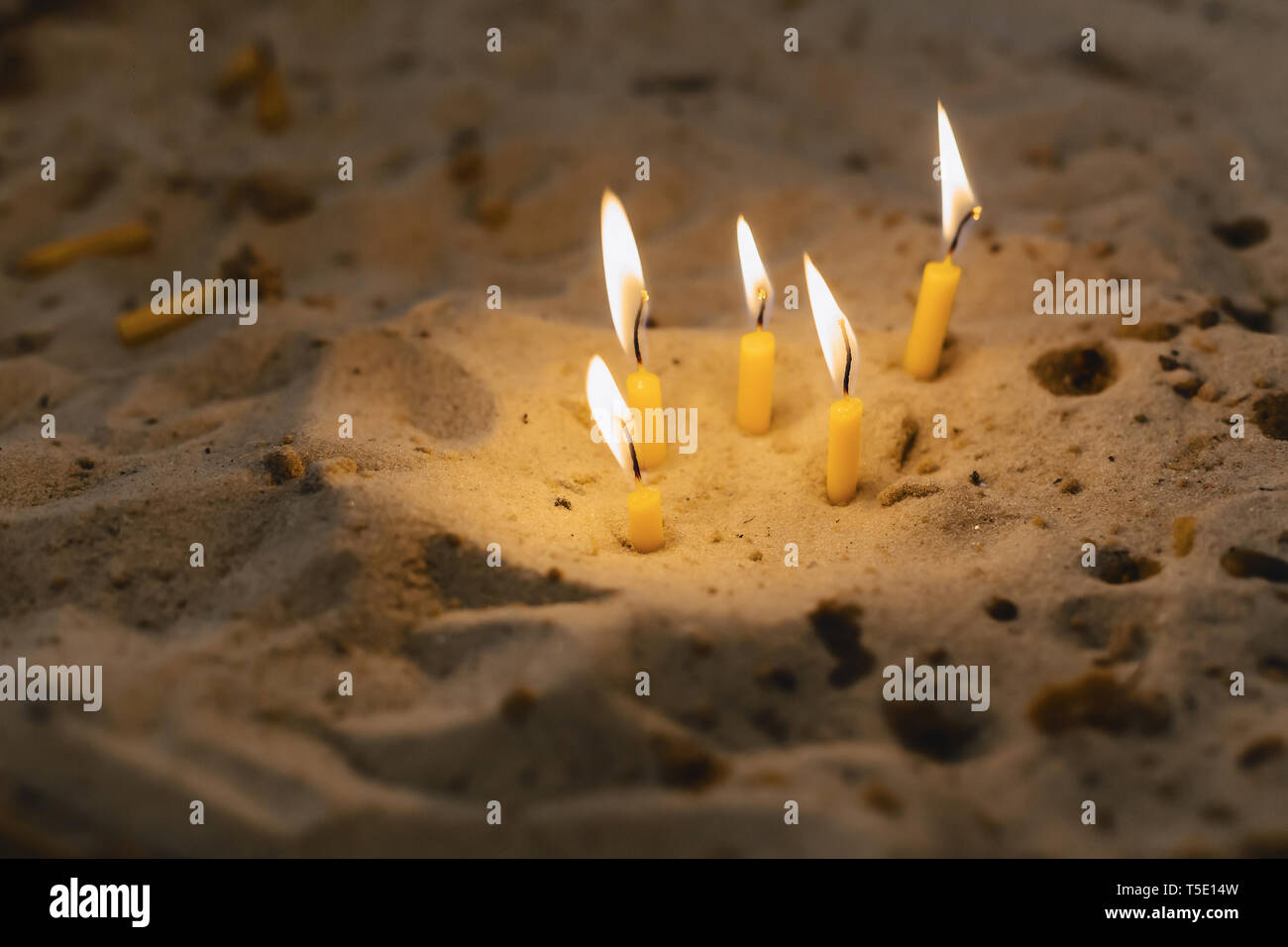 Lit candle in sand hi-res stock photography and images - Alamy