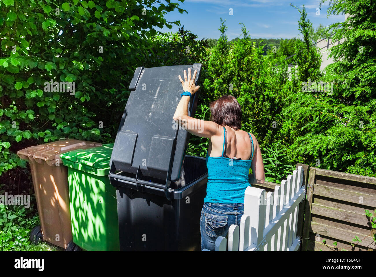 Woman full trash bin hi-res stock photography and images - Alamy