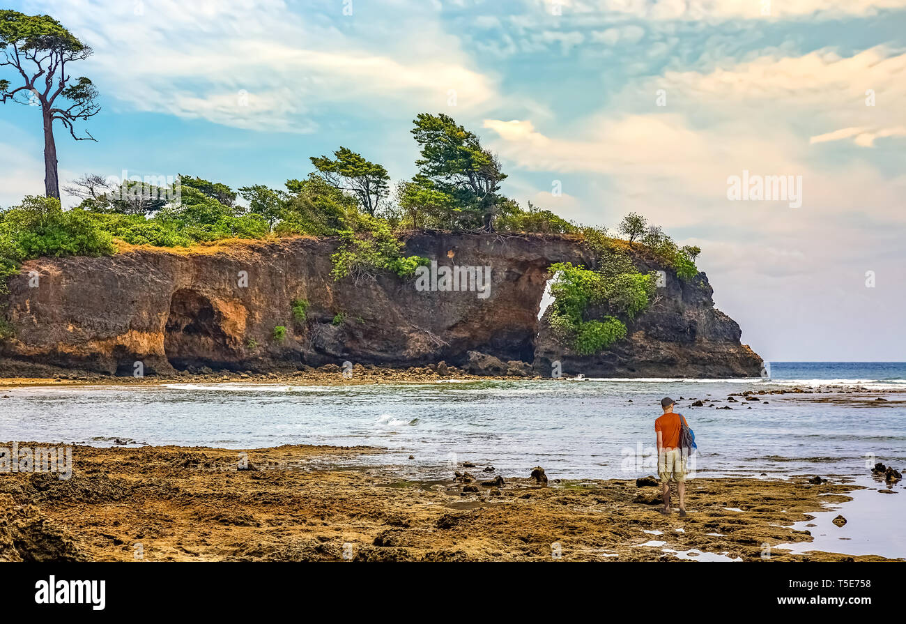 Neil island sea beach with natural rock formations. Male tourist enjoy ...