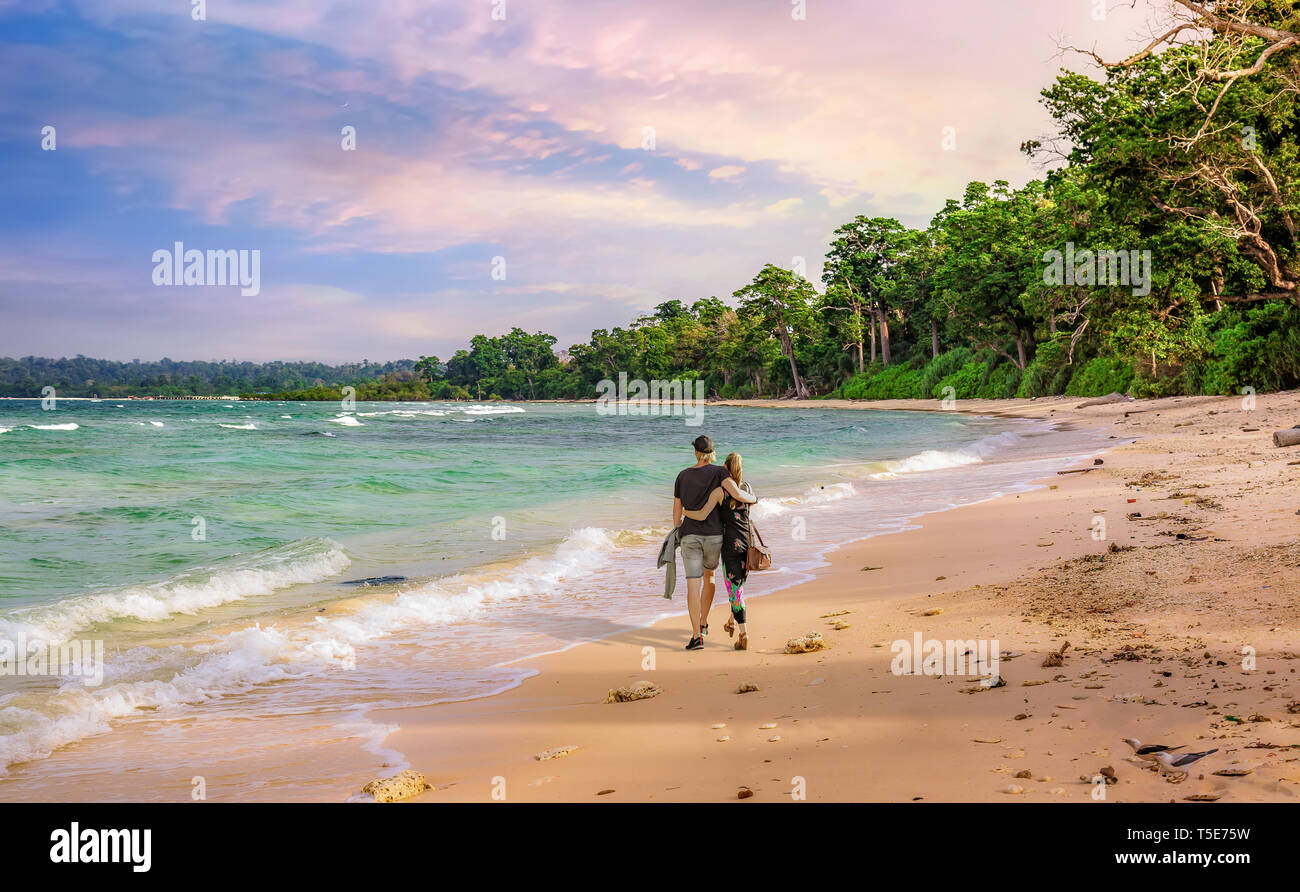 Honeymoon couple take a walk at the scenic Neil island sea beach at ...
