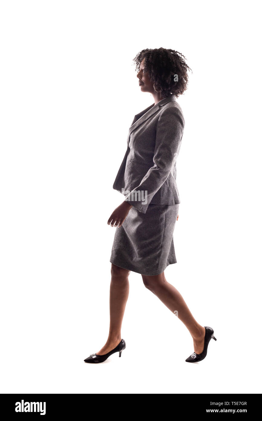 Side View of a Black Businesswoman walking in side view isolated on a ...