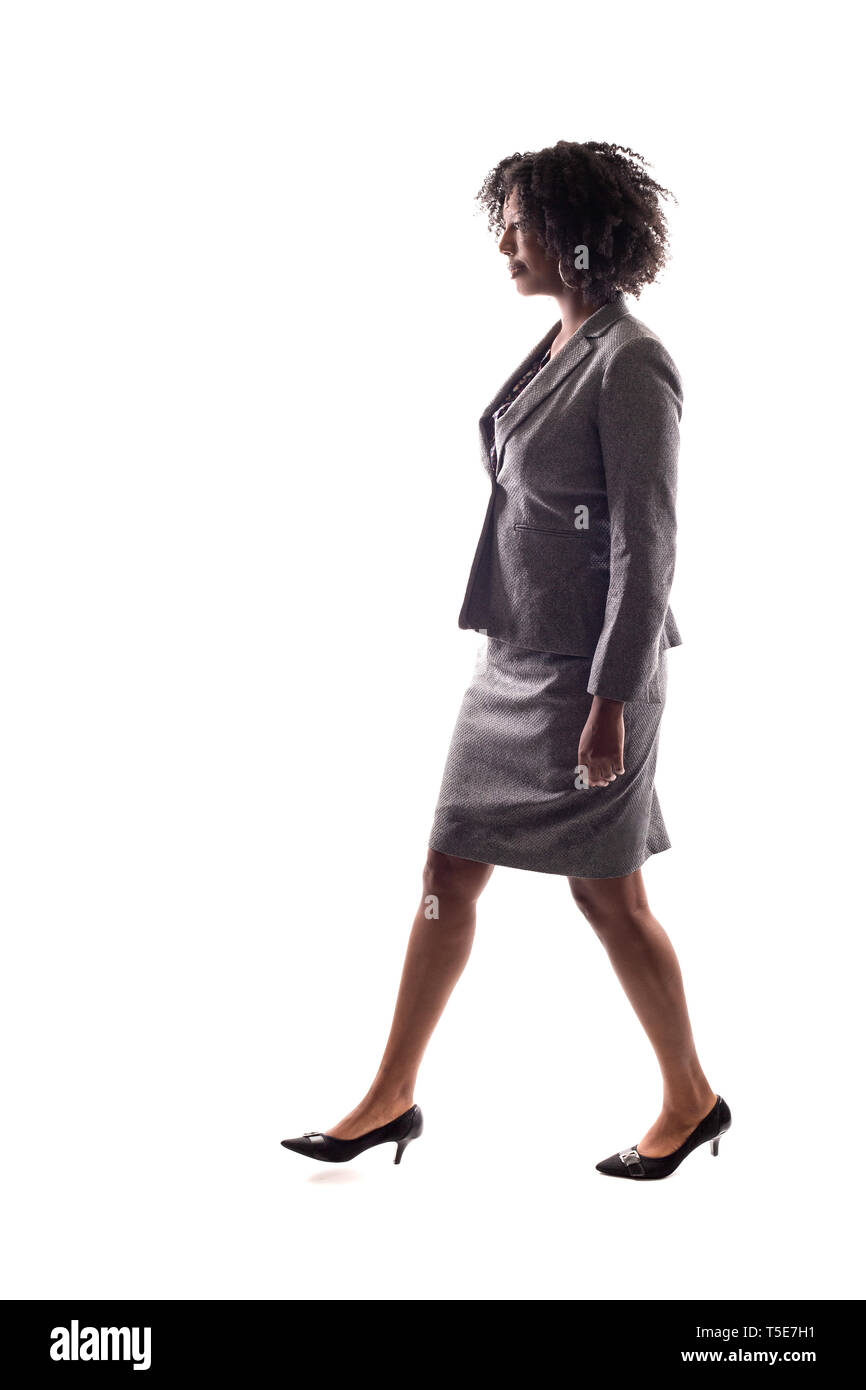 Side View of a Black Businesswoman walking in side view isolated on a ...