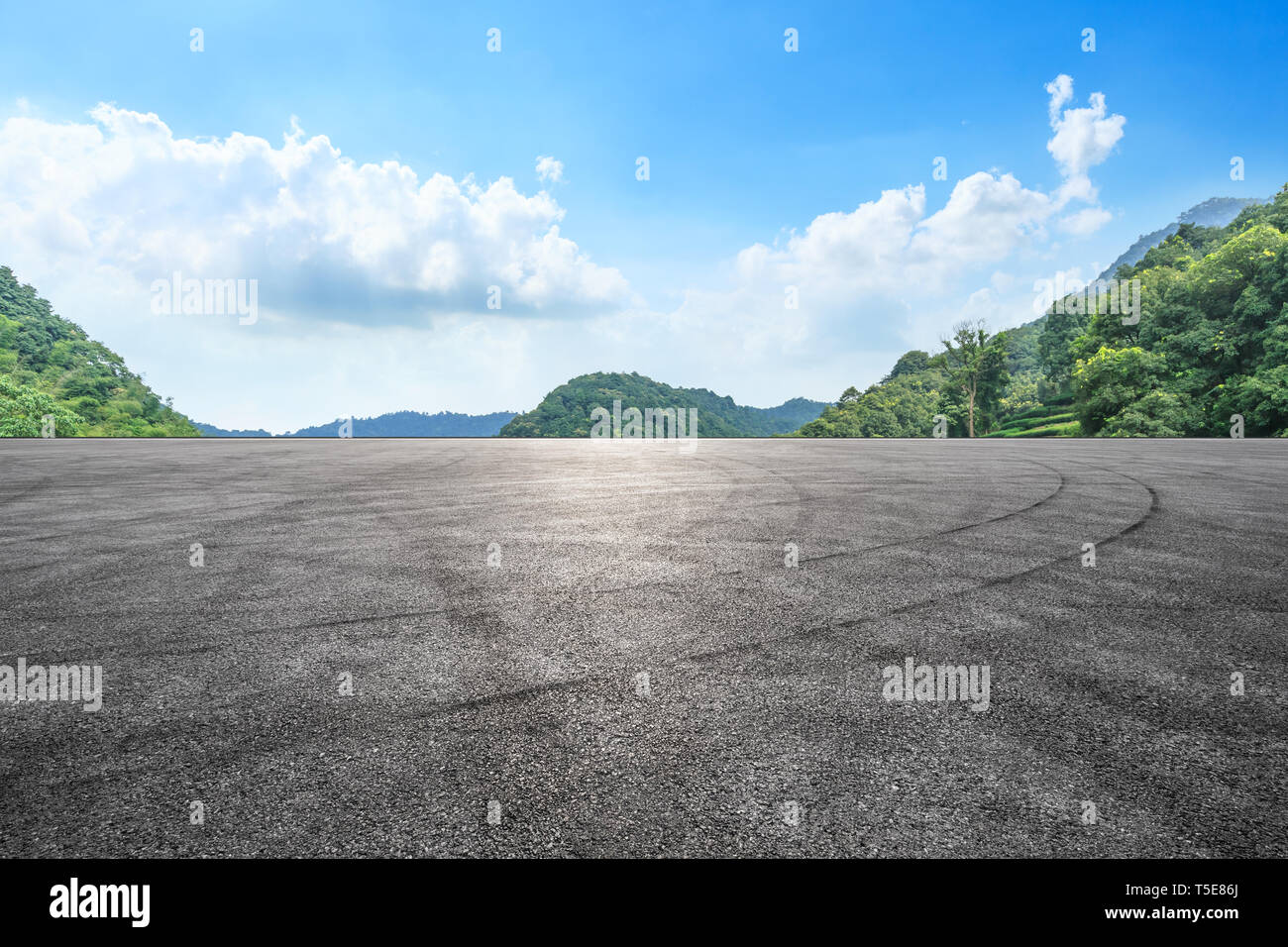 Asphalt race track ground and mountains with blue sky landscape Stock ...