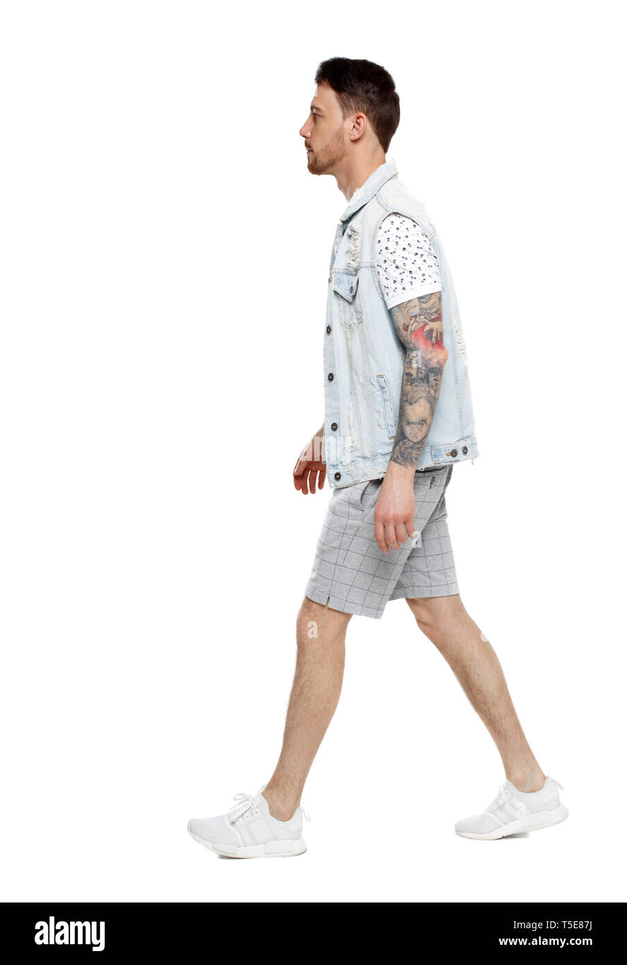 Back view of going handsome man in a shorts. walking young guy . Rear ...