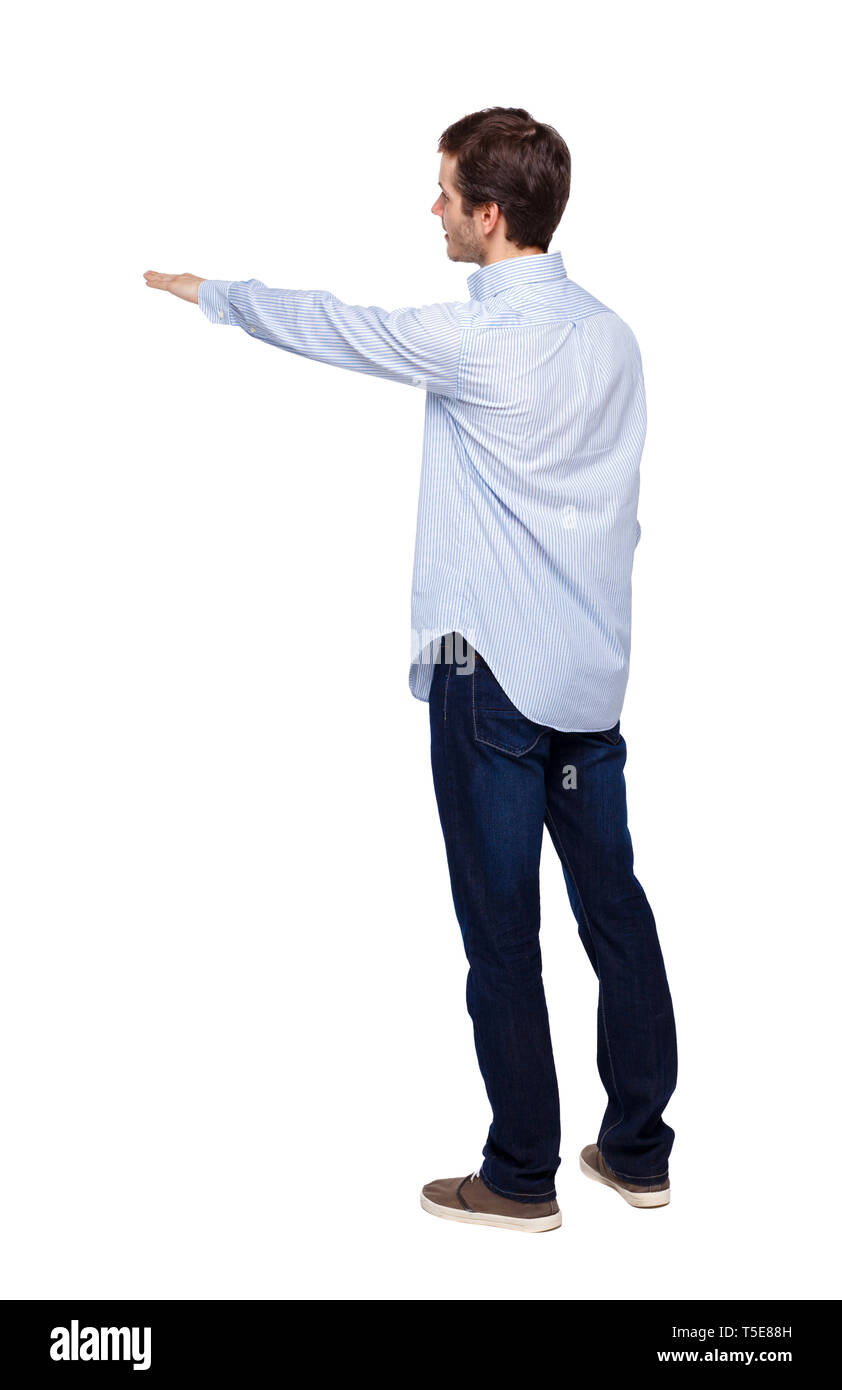Back view of a man in jeans points his hand upwards. Rear view people ...