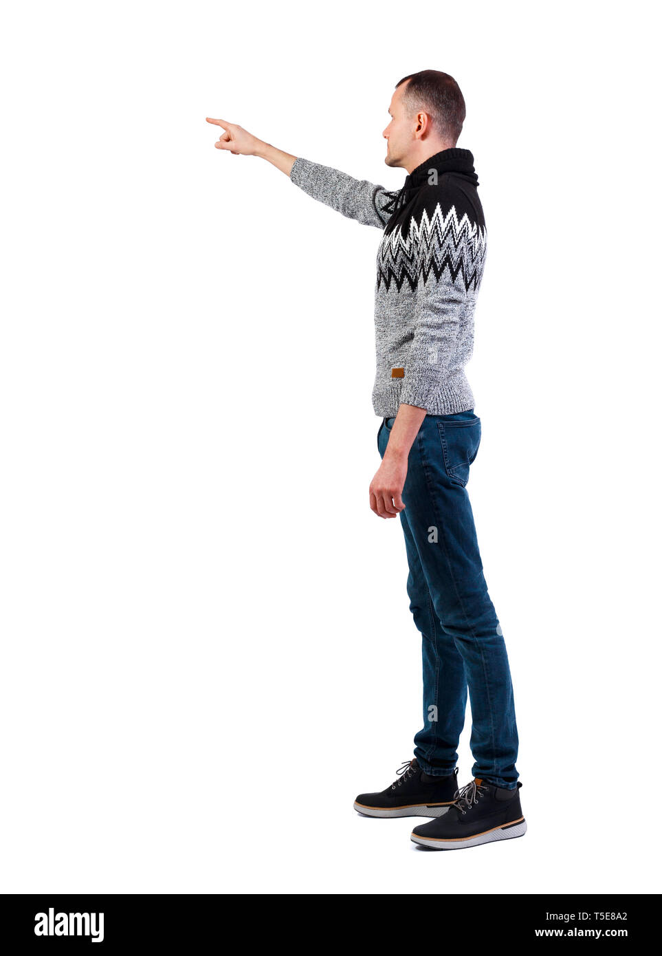 Side view of a man in jeans points his hand upwards. Rear view people ...