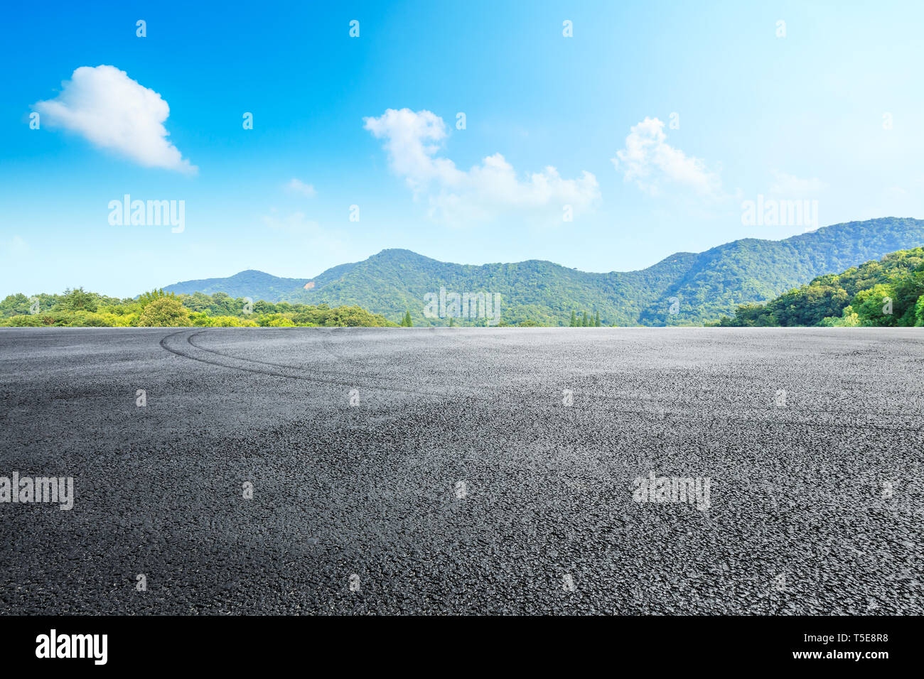 Asphalt race track ground and mountains with blue sky landscape Stock ...