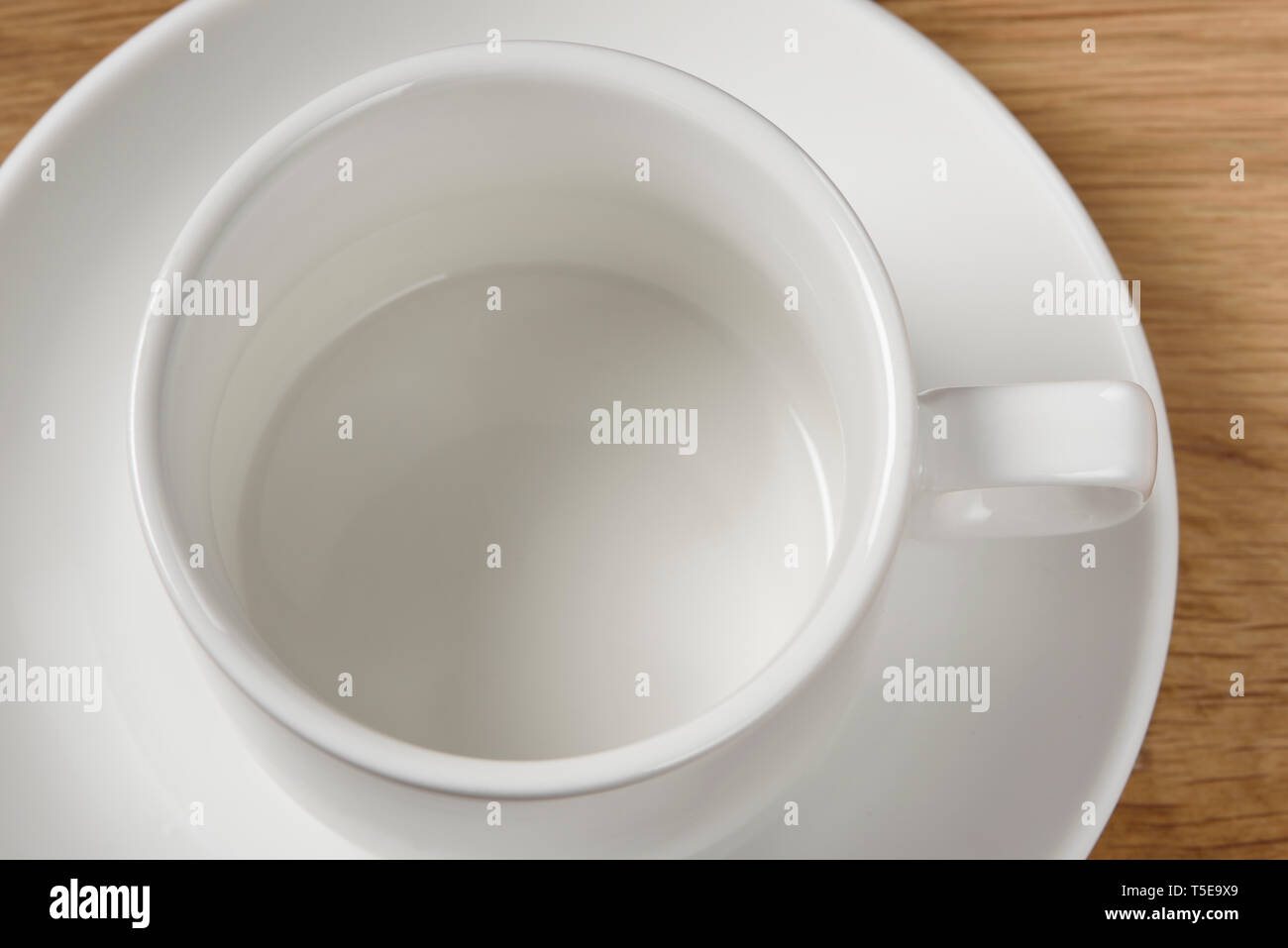 Empty white cup and saucer Stock Photo - Alamy