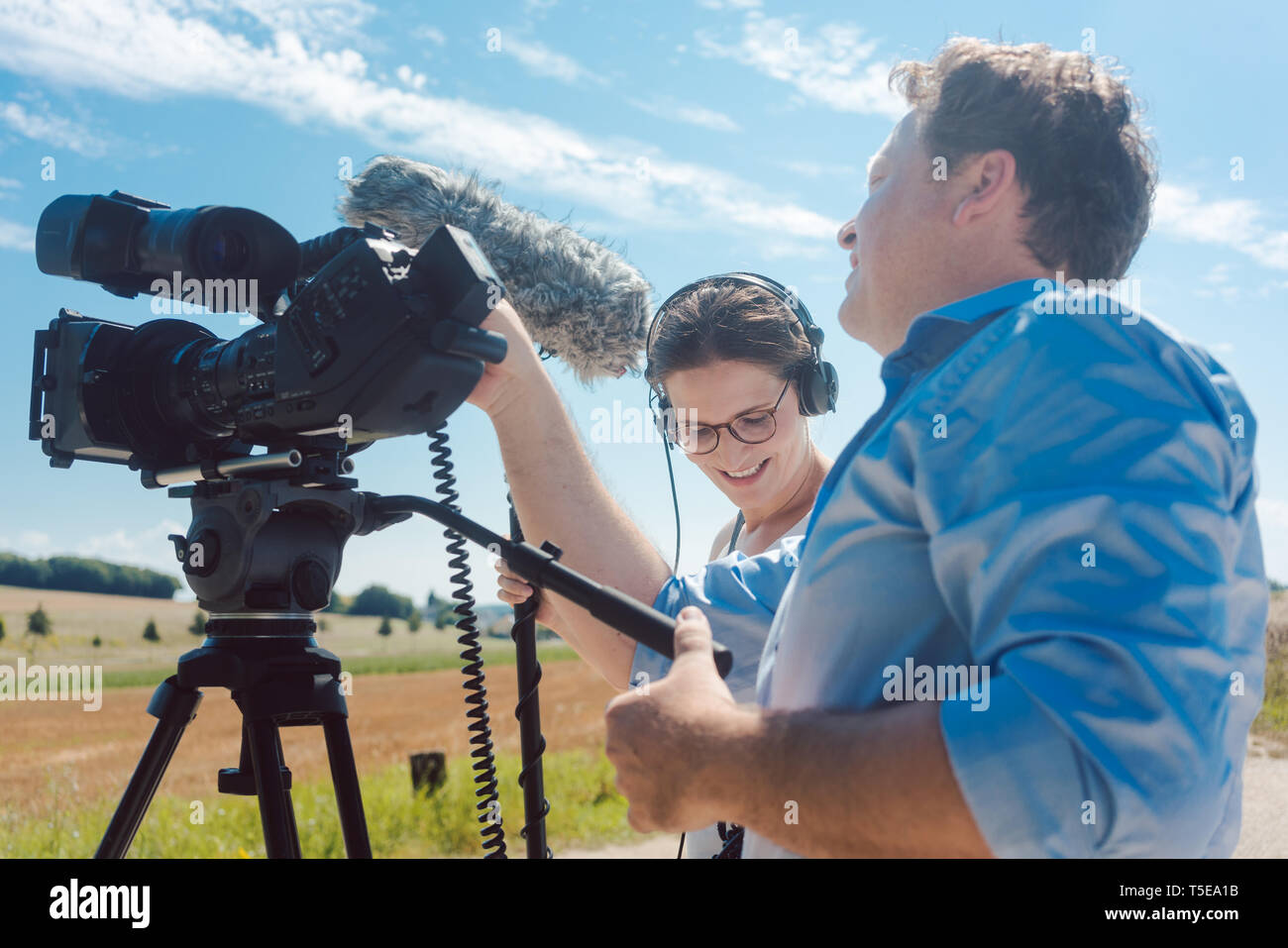 Cameraman with his camera and assistant working in production Stock ...