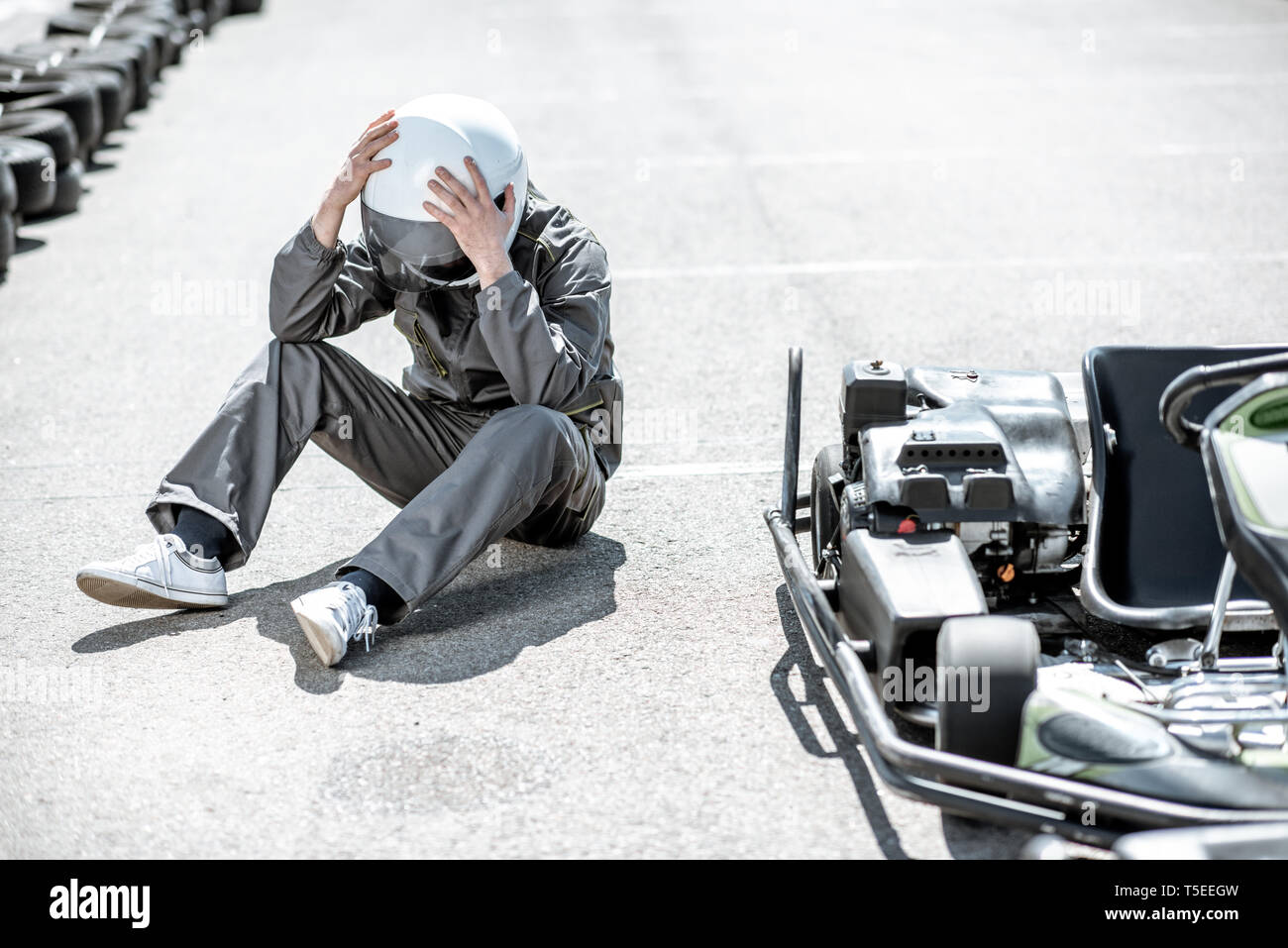 Despair racer in sportswear feeling sad lying on the track near the ...