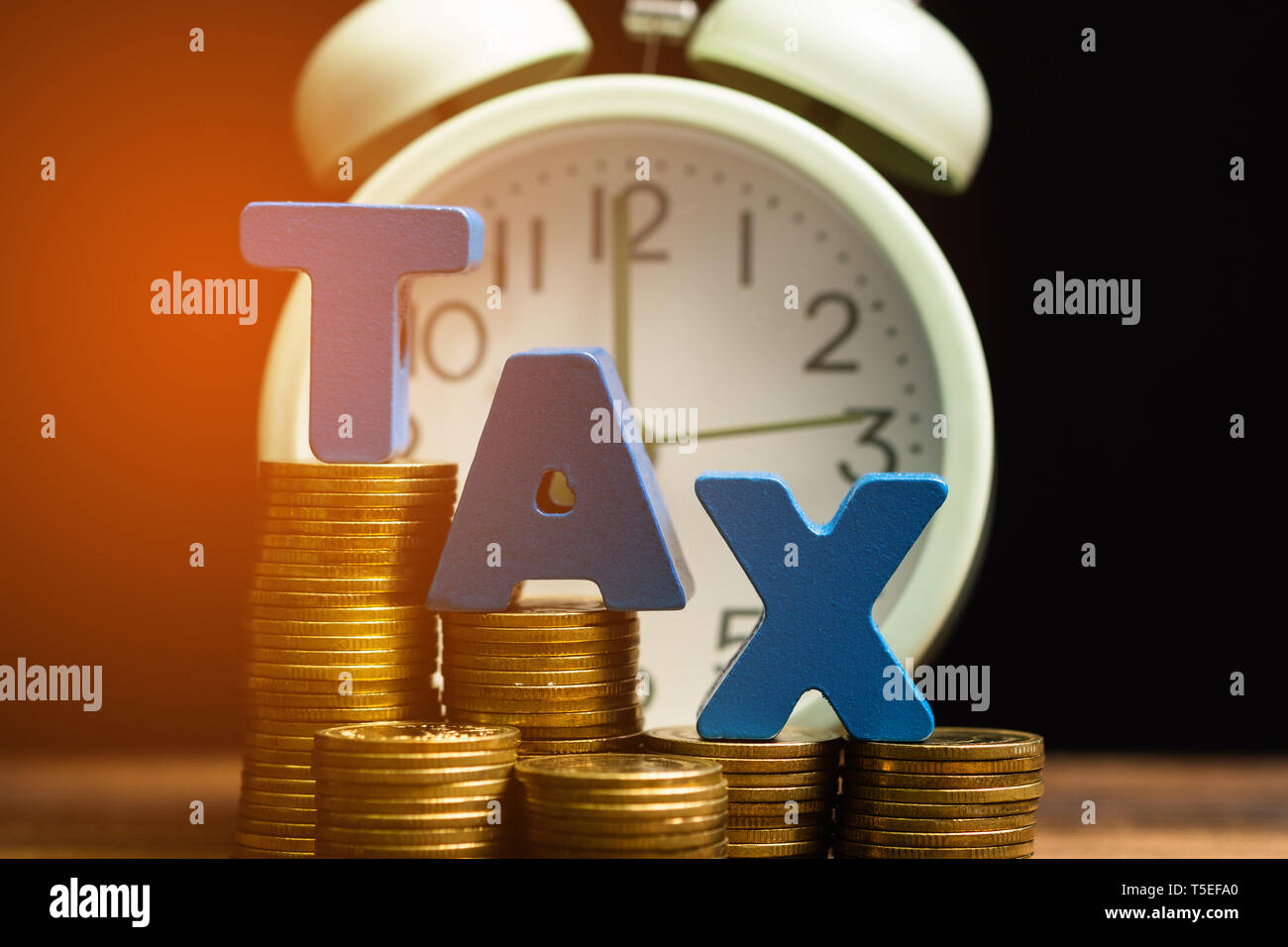 Time to pay TAX concept. TAX alphabet with stack of coin and vintage ...