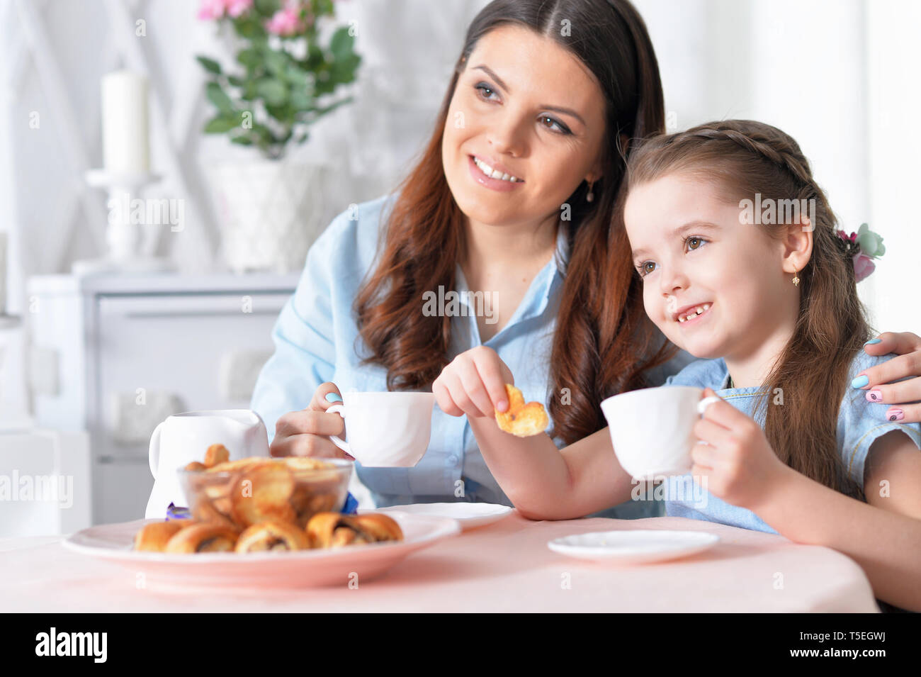 Close up portrait of little girl with mother drinking tea at home Stock ...