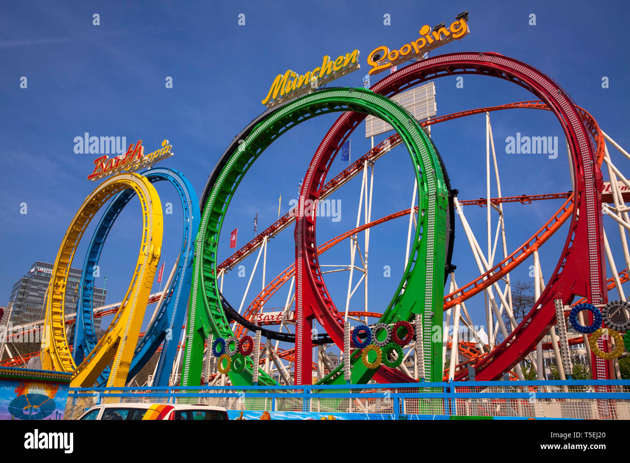 roller coaster with loops on the fair on the banks of the river Rhine ...