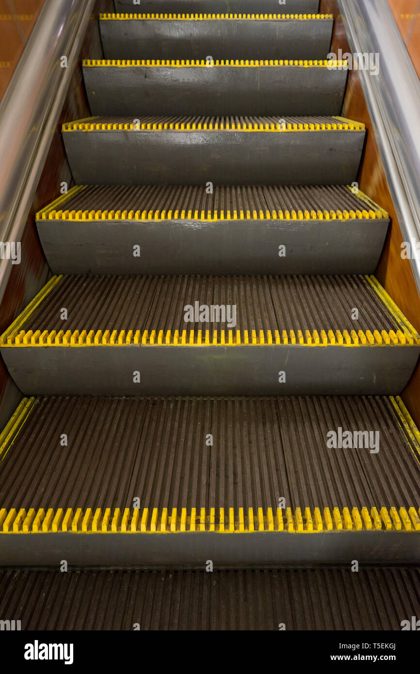 Old dirty escalator with yellow warning stripes in the subway Stock ...
