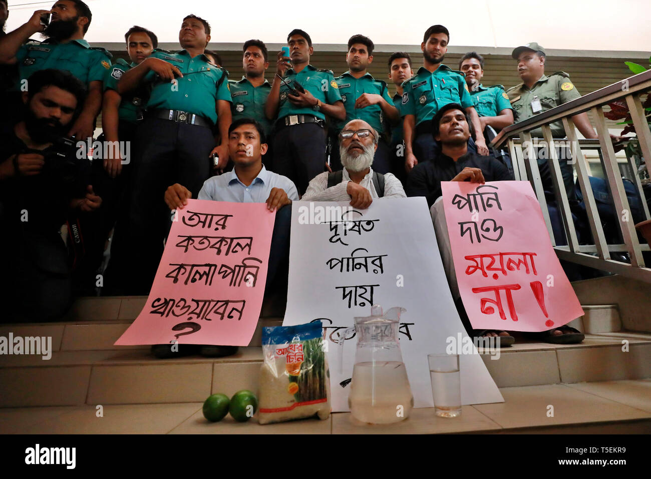 Dhaka, Bangladesh - April 23, 2019: A family sits on the stairs of the ...