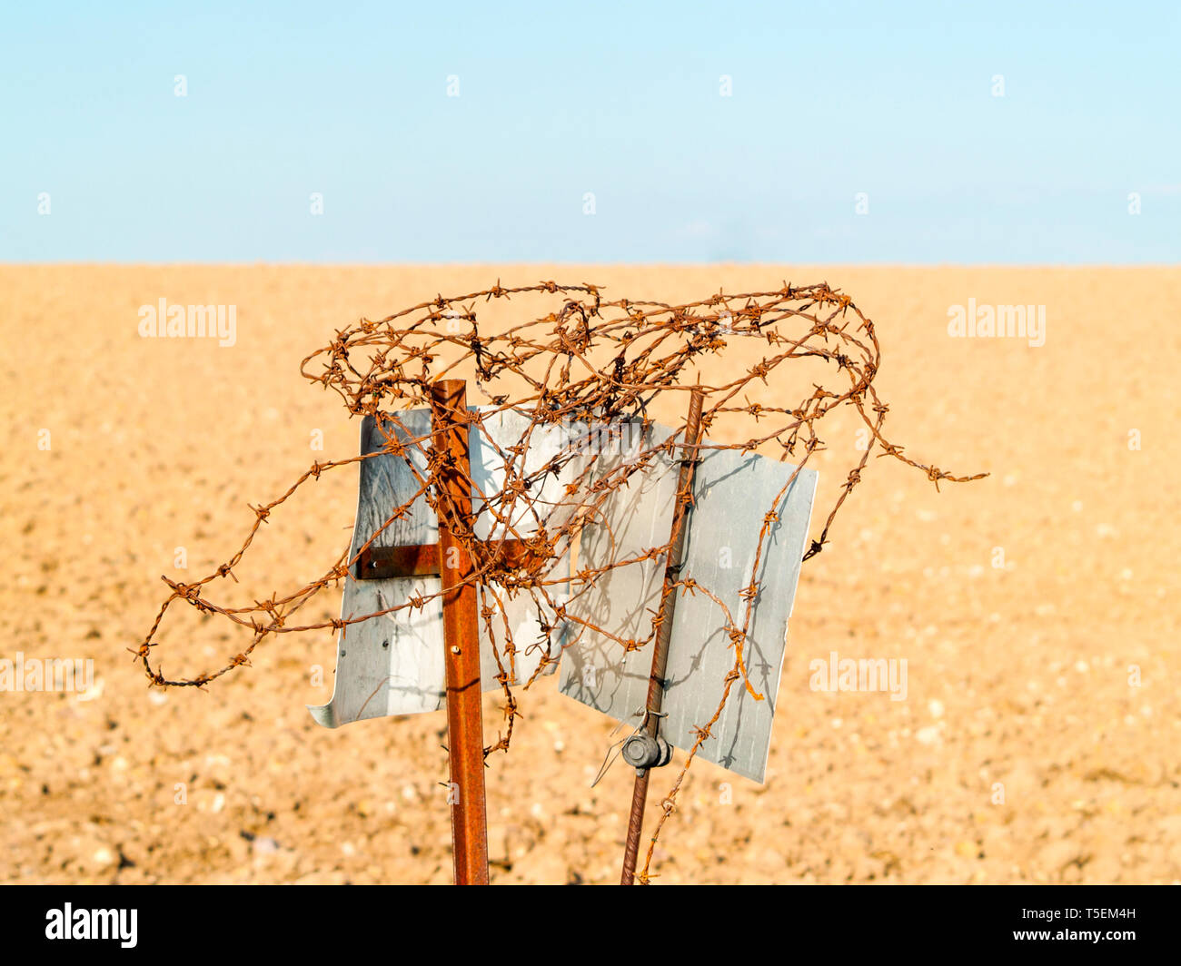 Barbed wire tangled up on countryside Stock Photo - Alamy