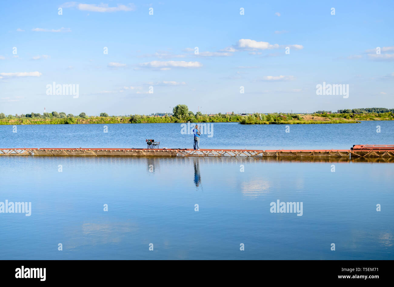 fisherman caught fish. Caucasian man catch fish on lake. Angler on ...