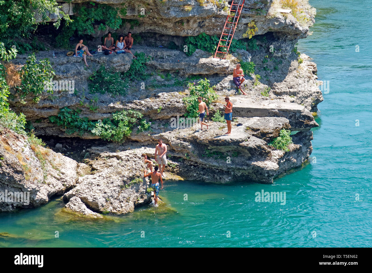 swimmers, rock shoreline; Neretva River; water, fun, relaxation, Mostar ...