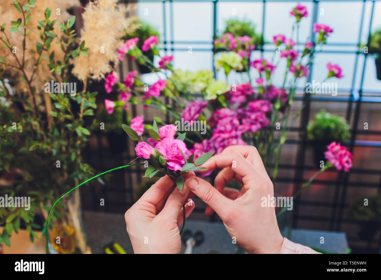 Process of creating a bouquet florist flower shop close-up. Woman hands ...