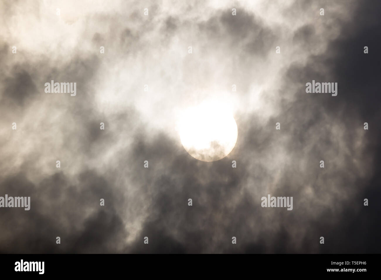 the sun hide behind grey cloud on evening Stock Photo - Alamy