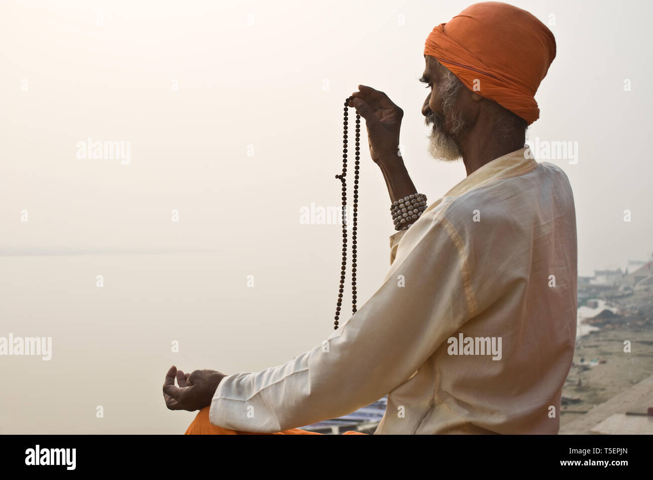 Hindu man worshipping the sun god near the Ganges river ( India Stock ...