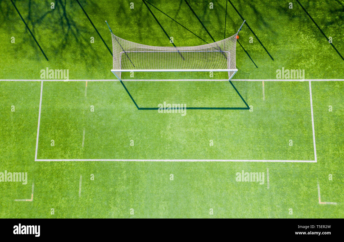 Football net on the background of a green football field. Aerial view ...