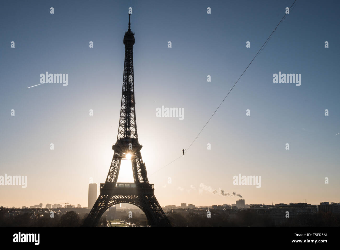 PARIS, FRANCE - DECEMBER 08: a man walk on a highline between Eiffel ...