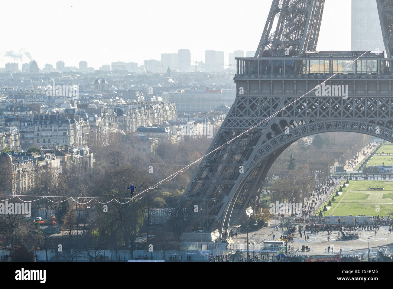 PARIS, FRANCE - DECEMBER 08: a man walk on a highline between Eiffel ...