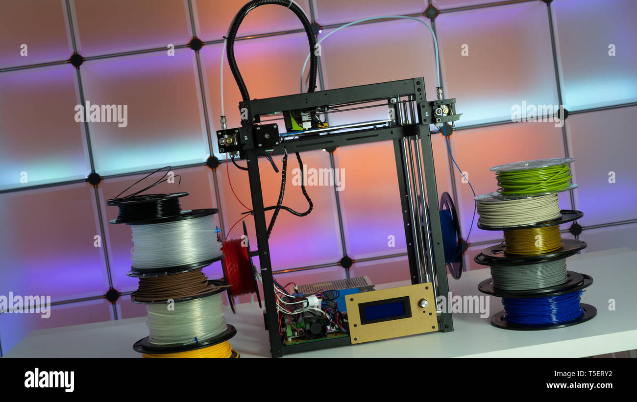 3d printer and plastic filament on color background Stock Photo - Alamy