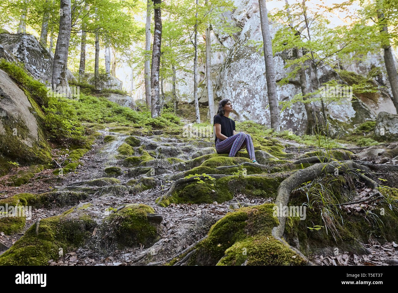 Beautiful woman meditating on rock hi-res stock photography and images ...