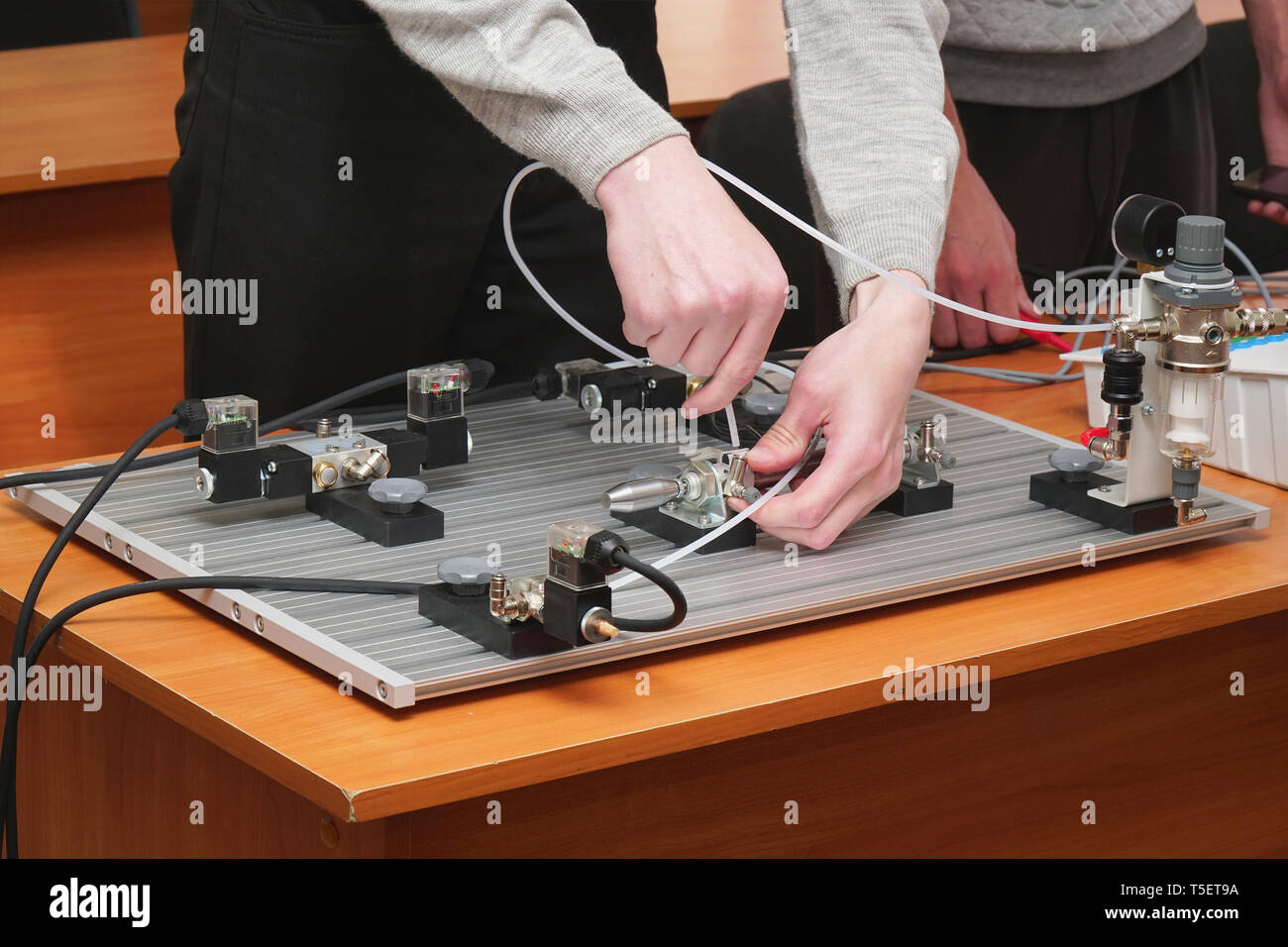 Engineers connect wires control panel with small test bench for ...