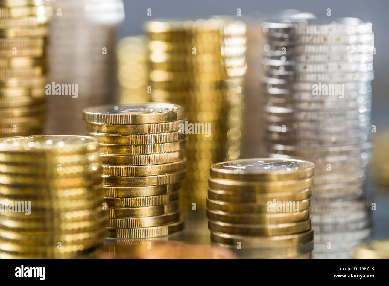 Towers of the euro coins stacked in different positions Stock Photo - Alamy