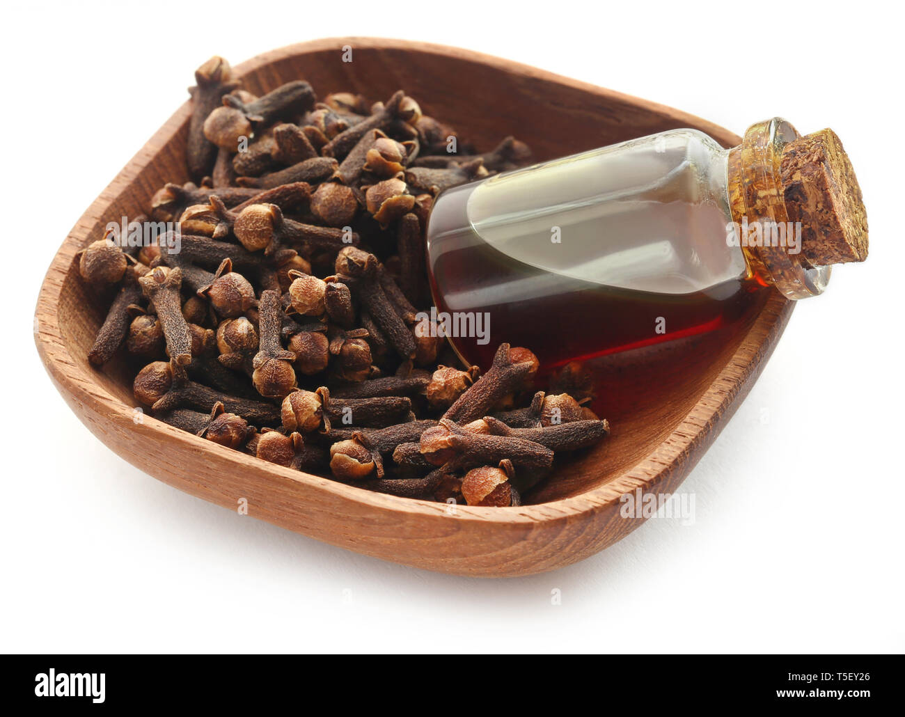 Fresh clove in bowl with oil in a jar over white background Stock Photo ...
