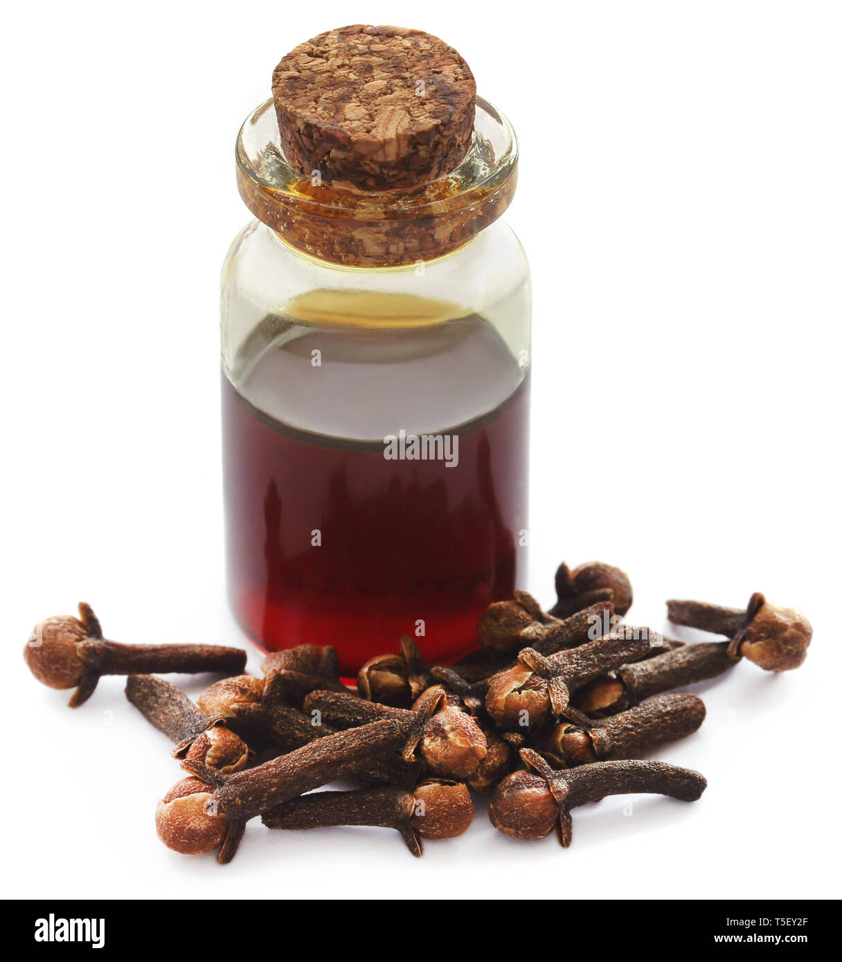 Fresh clove with oil in a jar over white background Stock Photo - Alamy