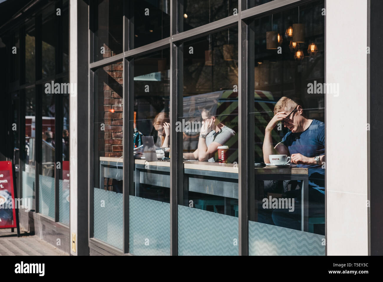 Reading cafe window street hi-res stock photography and images - Alamy