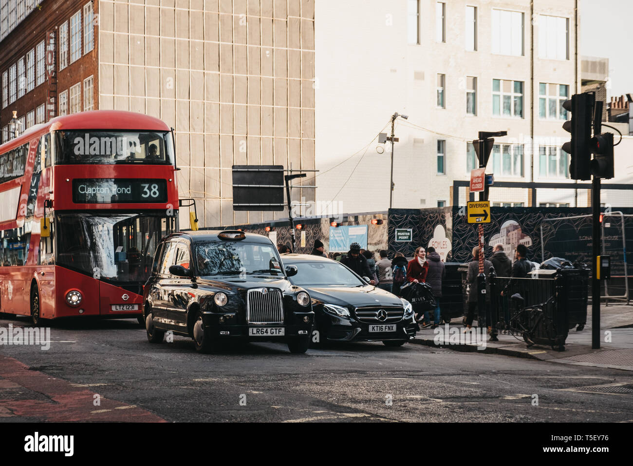 London, UK - April 13, 2019: Black cabs and a red double decker bus on ...