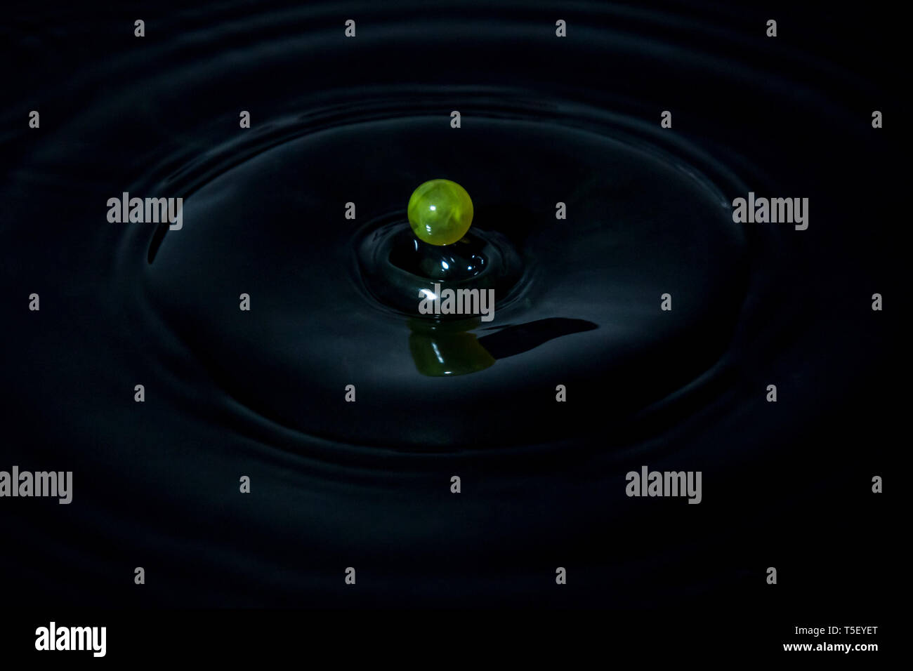 water drop splash in a glass, black backgrounds Stock Photo - Alamy