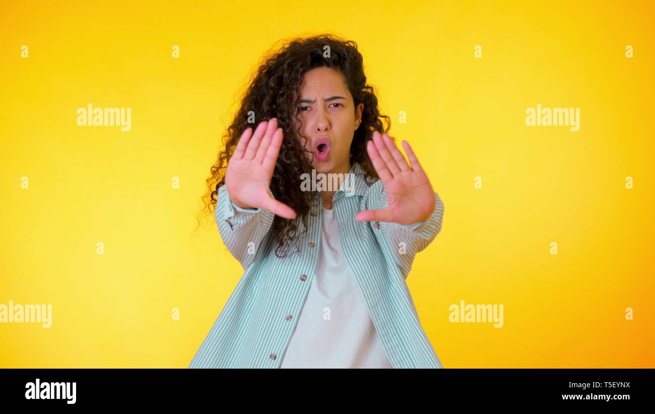 Angry annoyed woman raising hand up to say no stop. Sceptical and ...