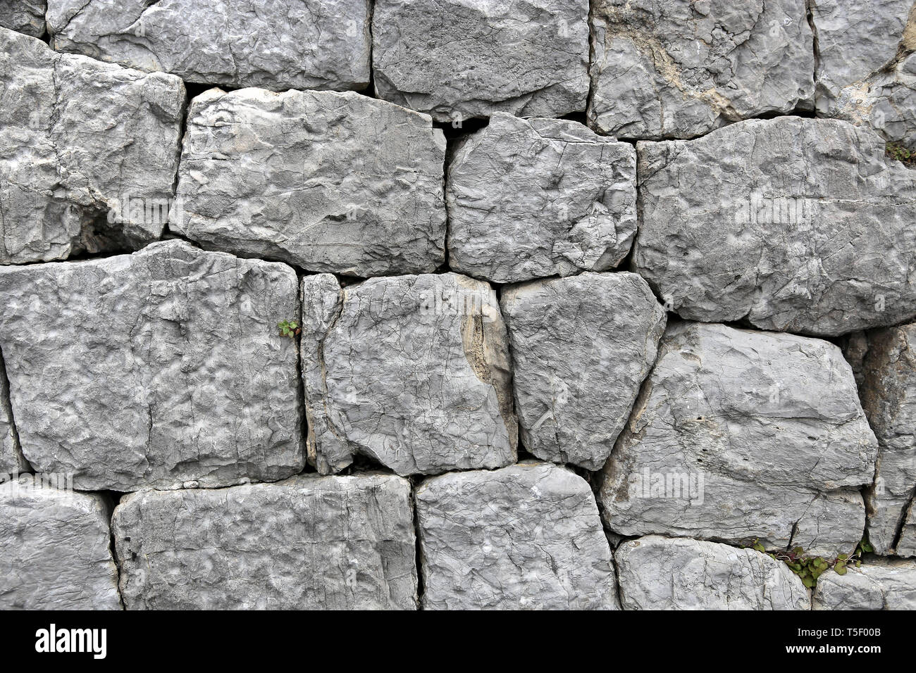 Ancient stone wall background closeup Stock Photo - Alamy