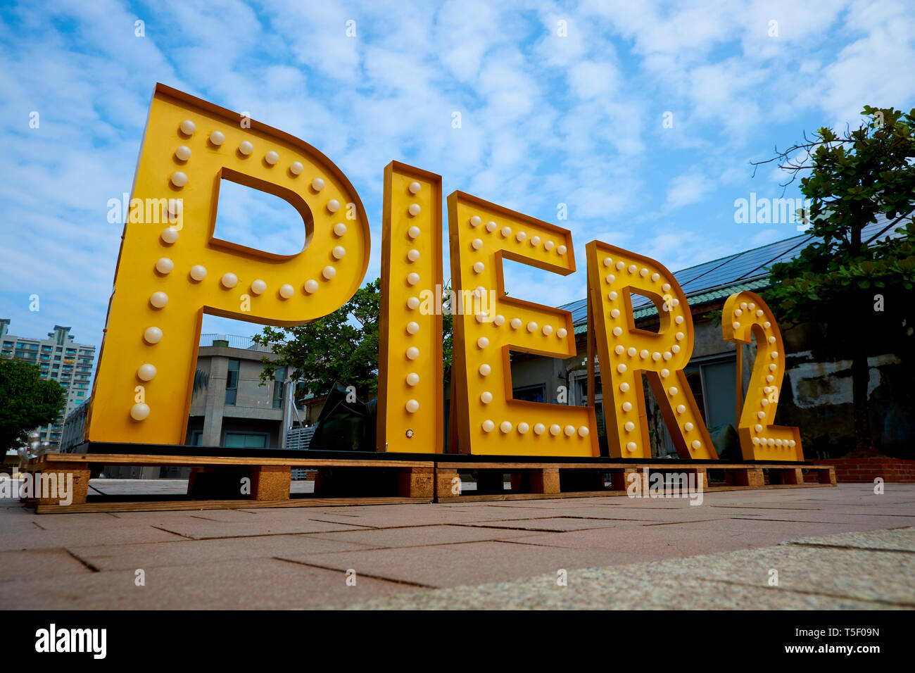 The yellow metal Pier 2 sign at the Art Center in Kaohsiung, Taiwan ...